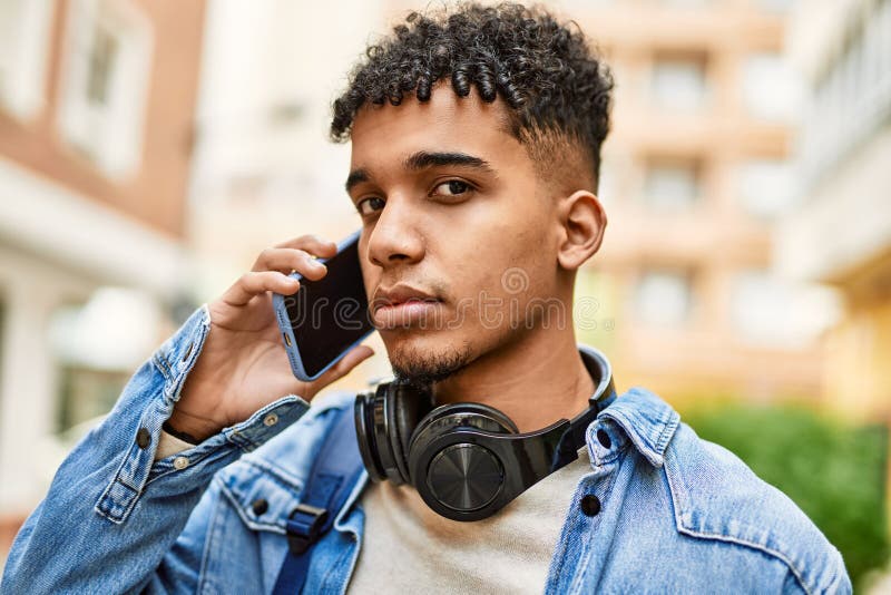 Hispanic Young Man Speaking on the Phone at the Street Stock Image ...