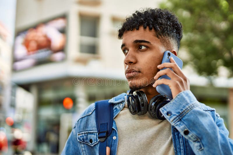 Hispanic Young Man Speaking on the Phone at the Street Stock Image ...