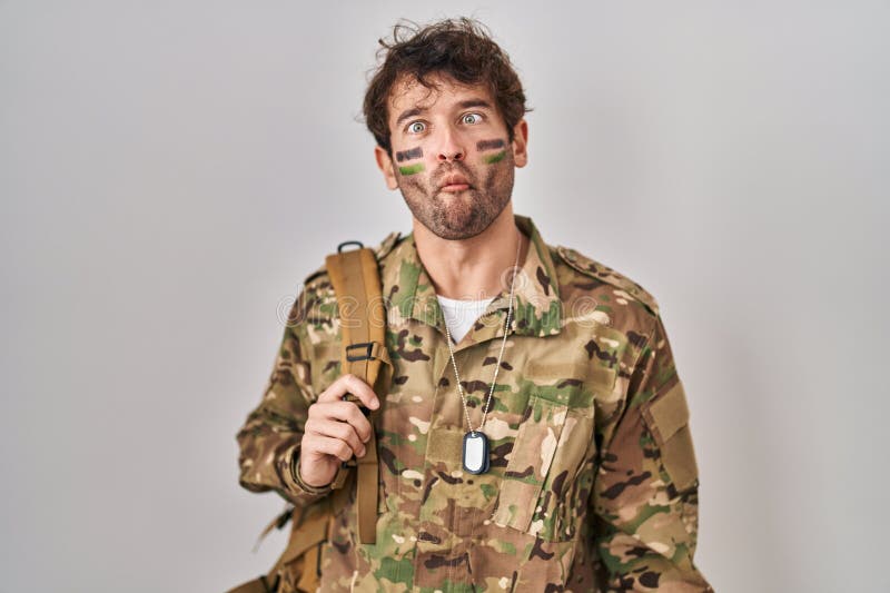 Hispanic Young Man Wearing Camouflage Army Uniform Making Fish Face ...