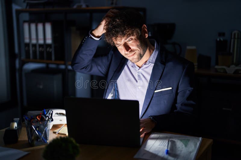 Hispanic Young Man Working at the Office at Night Confuse and Wonder ...