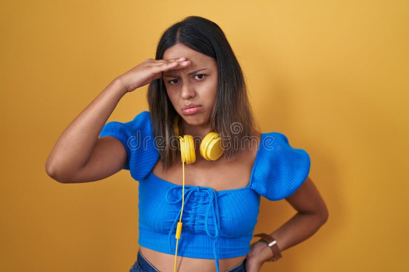 Hispanic Young Woman Standing Over Yellow Background Worried and ... Hispanic Young Woman Standing Over Yellow Background Worried and ...