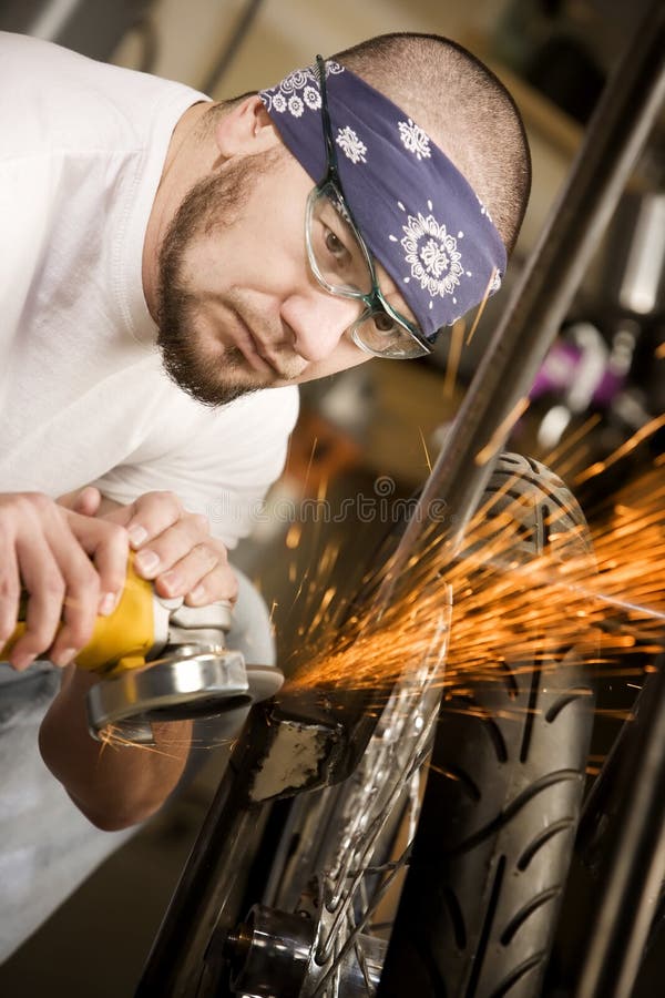 Hispaninc Man Using Grinder on Motorcycle Stock Image - Image of ...