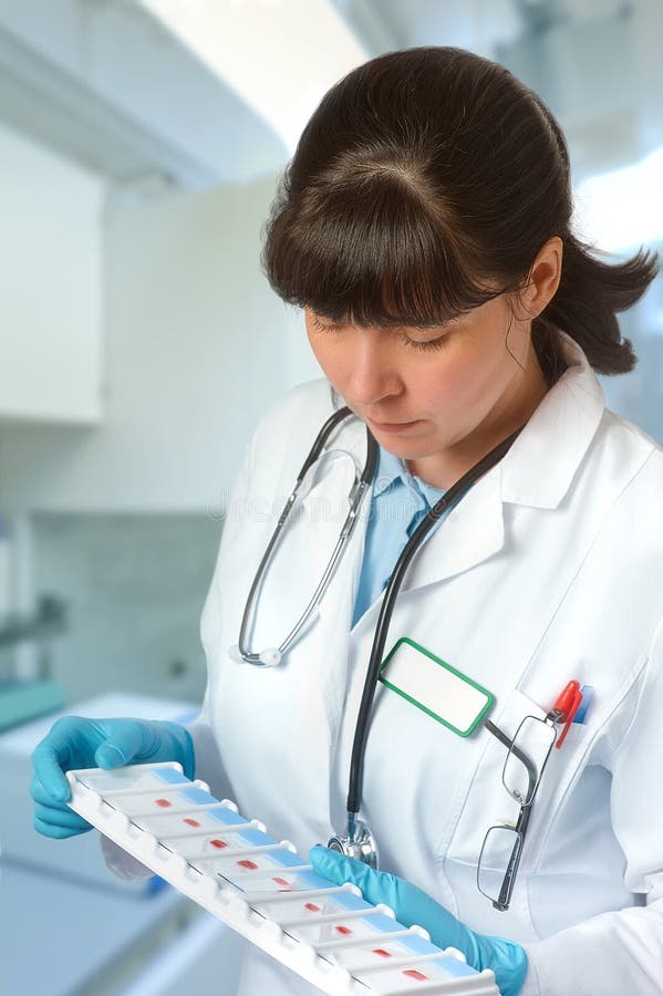 Histologist with a Microscope and a Tray of Microscopic Slides Stock ...