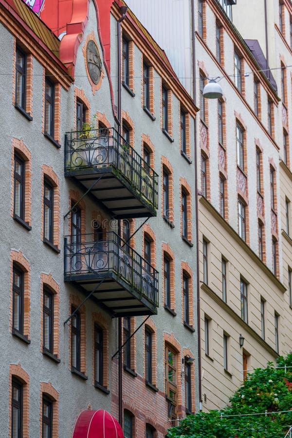 Historic Brick Building with Balconies and Red Roof.. Stock Image ...