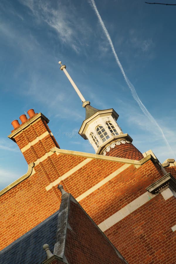 Historic Brick Building with a Distinctive Cupola Against a Blue Sky ...