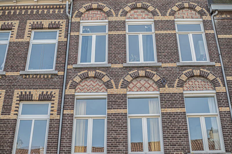 Historic Brick Building Facade with Arched Windows and Decorative ...