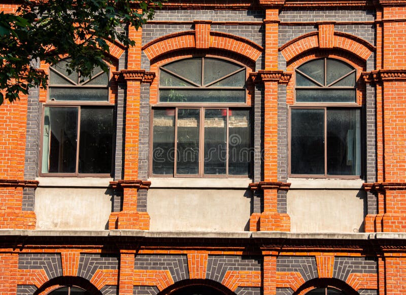 Historic Brick Building Facade with Large Windows Stock Image - Image ...