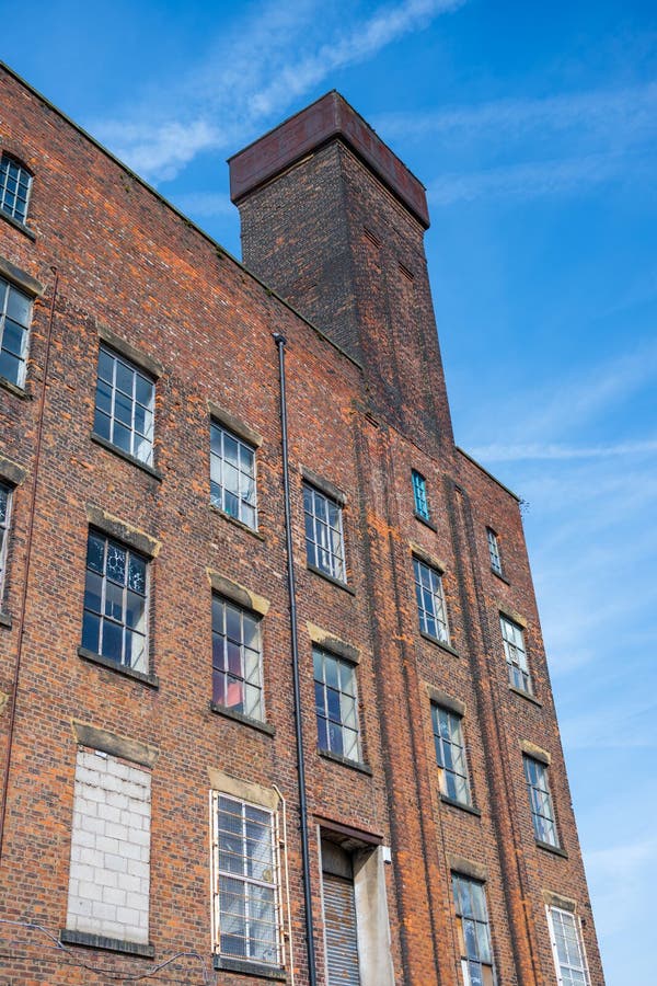 Historic Brick Mill with Tower Under a Clear Blue Sky Stock Photo ...