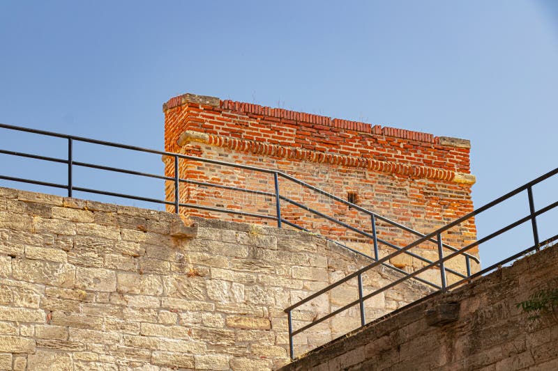 Historic Brick Structure with Railing Against a Clear Blue Sky in a ...