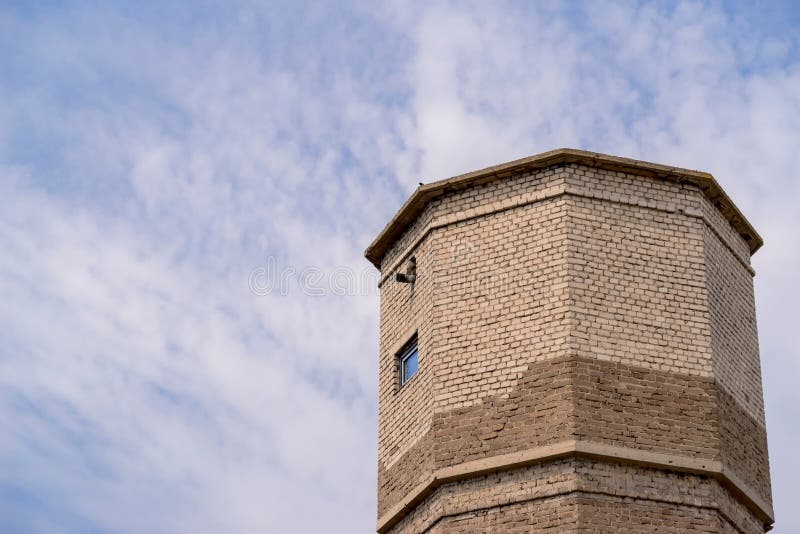 A Historic Brick Water Tower Against the Backdrop of a Sky with Light ...