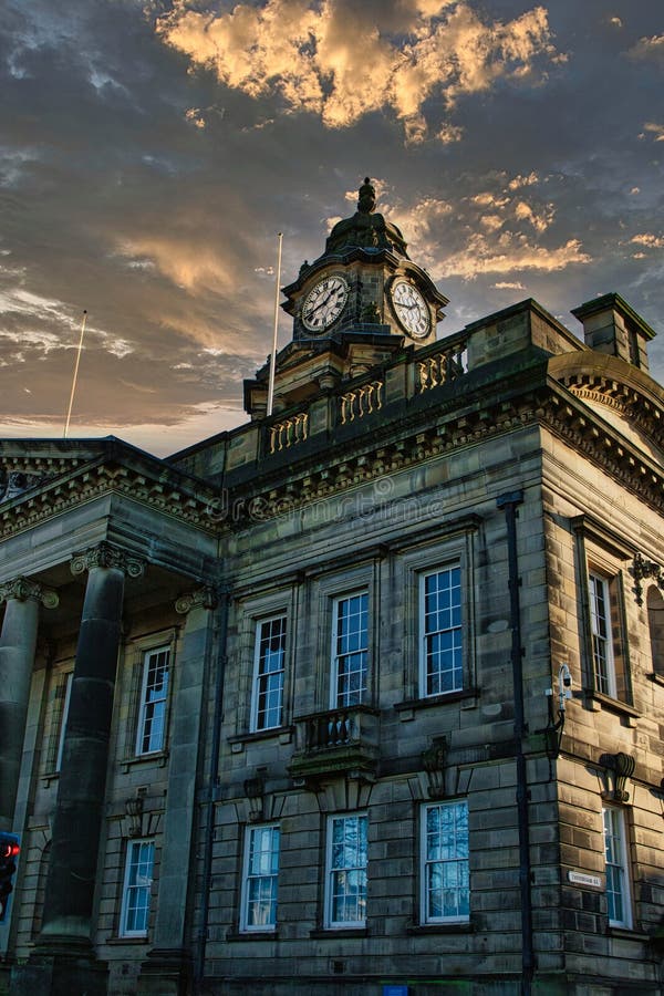 Historic Building with Clock Tower Against a Dramatic Sunset Sky in ...