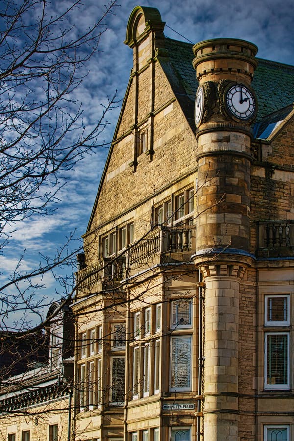 Historic Building with Clock Tower Under Blue Sky with Clouds in ...