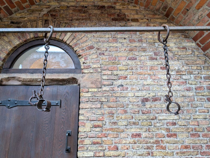 Historic Chains and Shackles Displayed on Brick Wall in a Museum ...