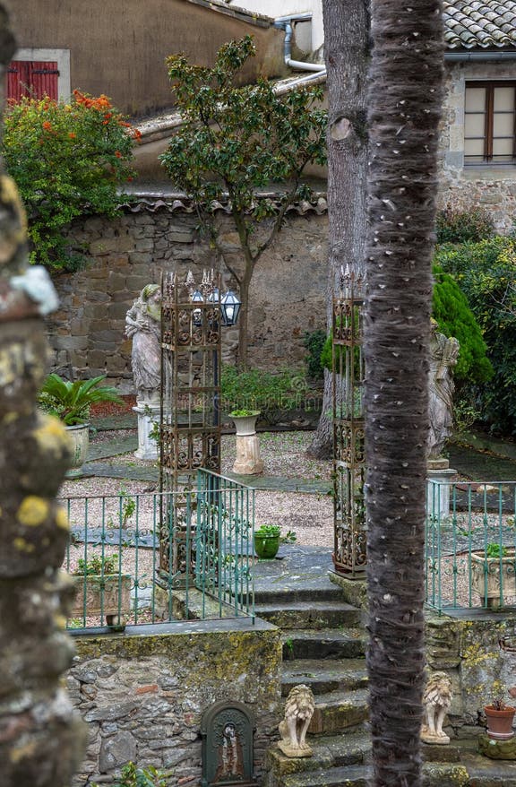 Historic Courtyard with Statues and Iron Gates in a Rustic Setting ...