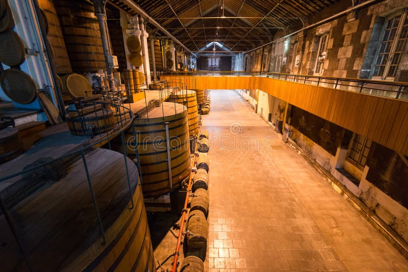Historic Distillery Interior Showcasing Large Wooden Fermentation Tanks ...