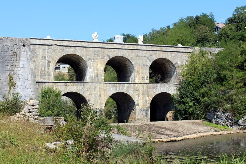 Historic Double-tier Stone Aqueduct with Arched Spans Over a River ...
