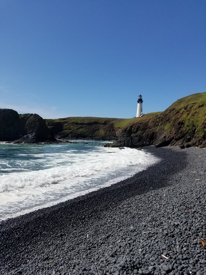 Historic Lighthouse and Black Beach Oregon Coast Stock Photo - Image of ...
