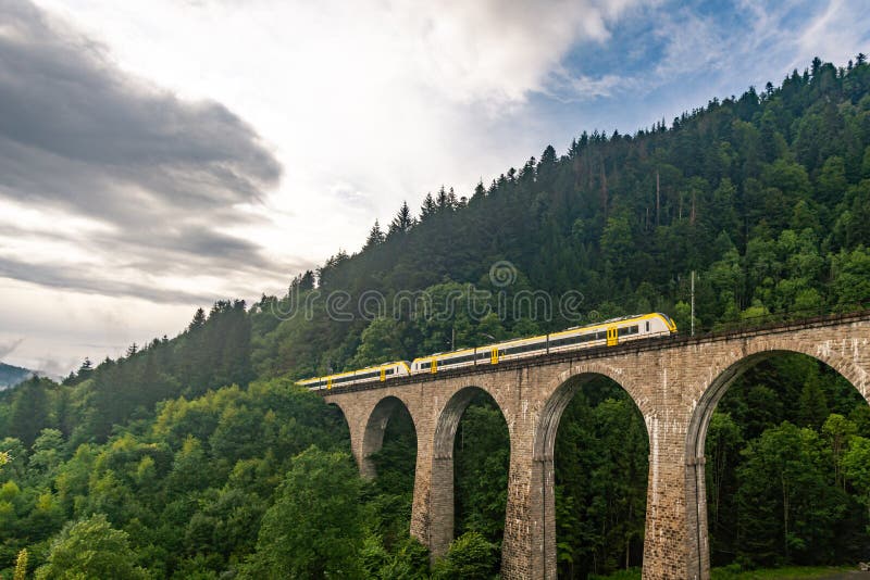 Historic Railway Bridge with a Yellow Train at the Ravenna Gorge Black ...