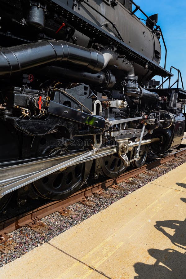 Historic Steam Engine Towers Over Shadows of Spectators Stock Photo ...