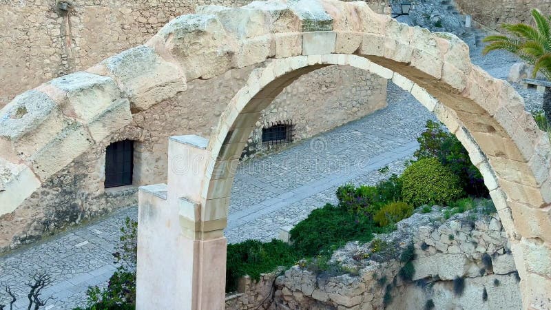A Historic Stone Archway Spans a Charming Cobblestone Pathway, Inviting ...