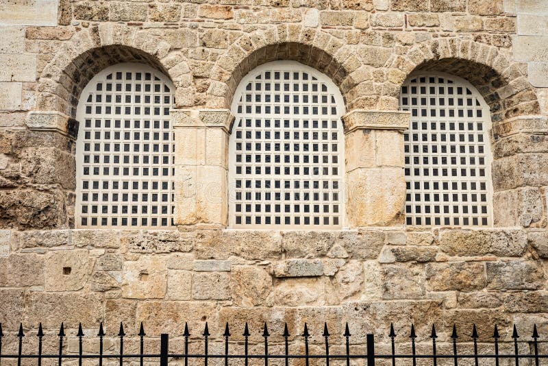 Historic Stone Building with Arched Windows and Iron Fence Stock Image ...
