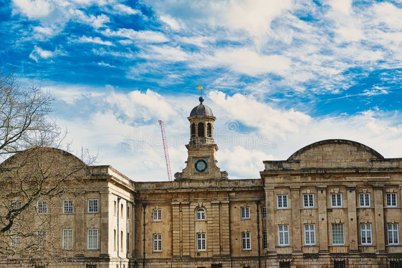 Historic Stone Building with a Central Clock Tower Under a Blue Sky ...