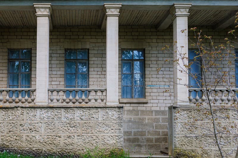 Historic Stone Building with Columns and Blue Windows Stock Image ...