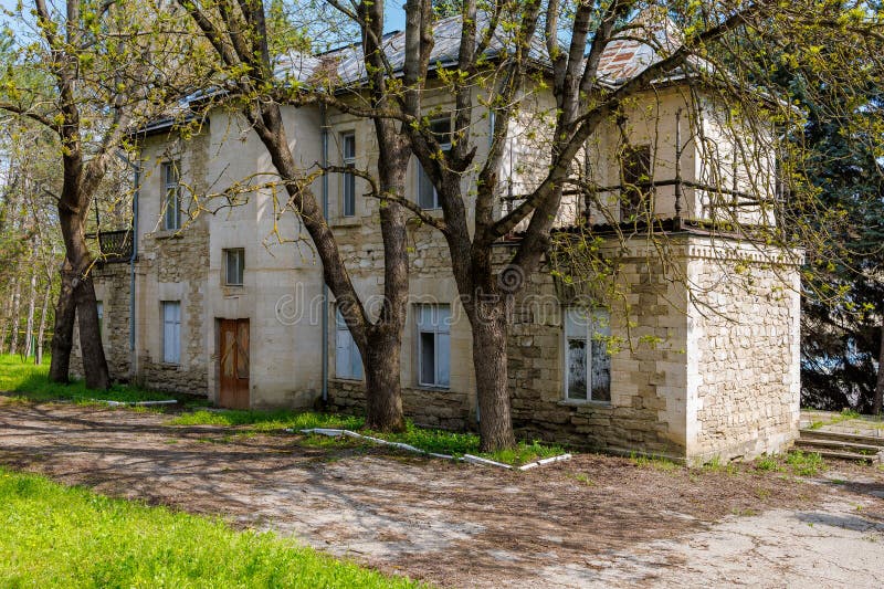 Historic Stone Building with Leafy Trees in a Sunny Park Setting Stock ...