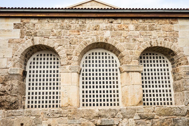 Historic Stone Building with Three Arched Windows and Grids Stock Photo ...