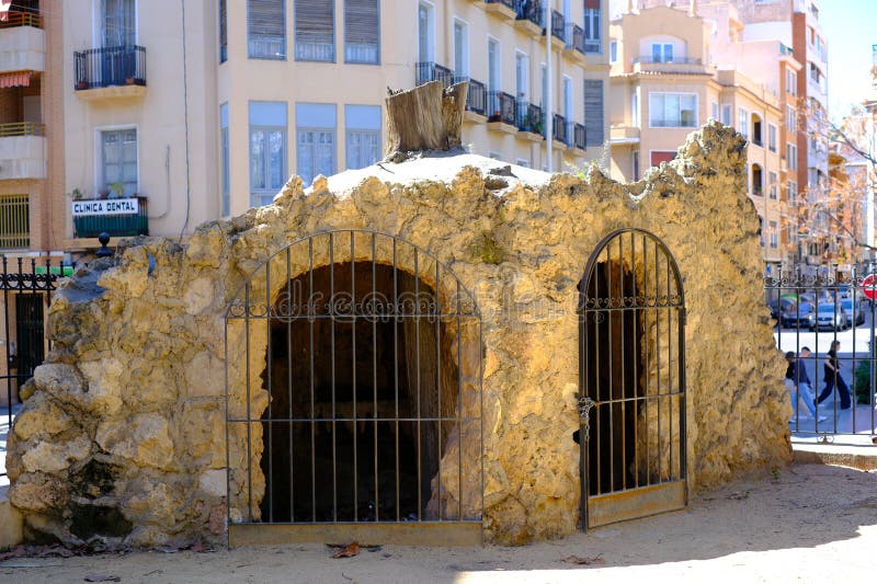 Historic Stone Cave Structure with Iron Gates in Urban Setting Stock ...