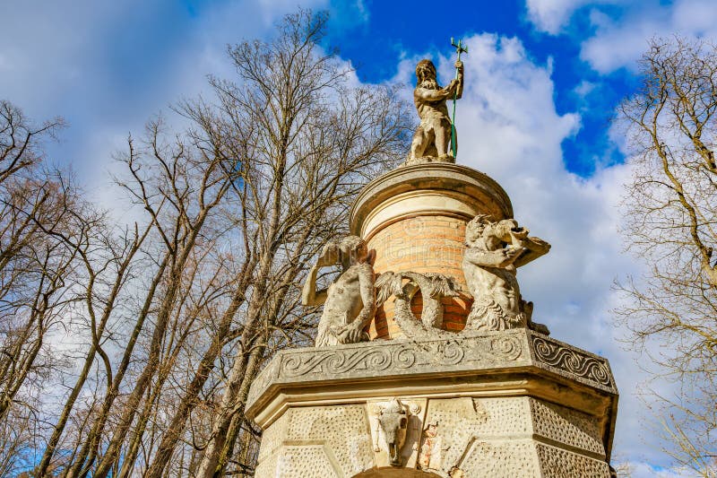Historic Stone Statue with Figures in Leafless Forest Under Blue Sky ...
