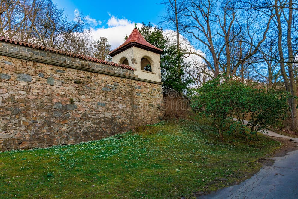 Historic Stone Wall and Tower in Serene Garden Setting with Pathway ...