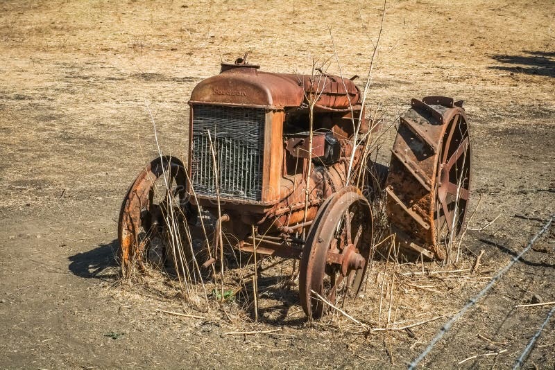 Historic Tractor Rusting in Open Field Fenced Stock Photo - Image of ...