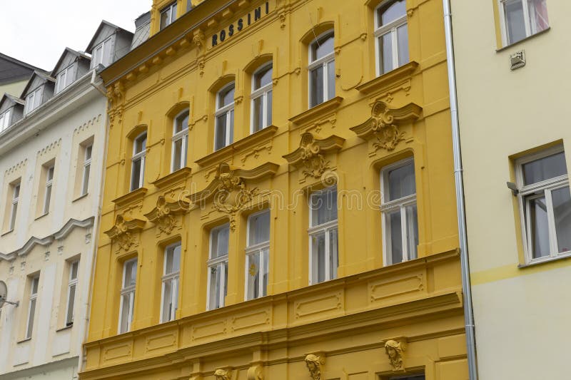 Yellow Historic Building Facade with Windows and Decorative Elements ...