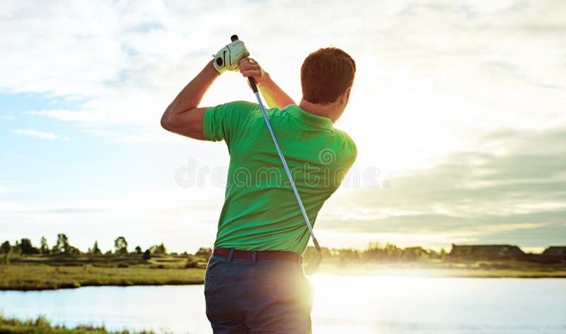 Hit Strong, Go Long. a Man Practicing His Swing on the Golf Course ...