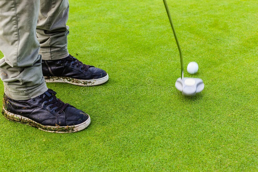 Hitting a Golf Ball with a Putter Stock Photo - Image of grass, putter ...