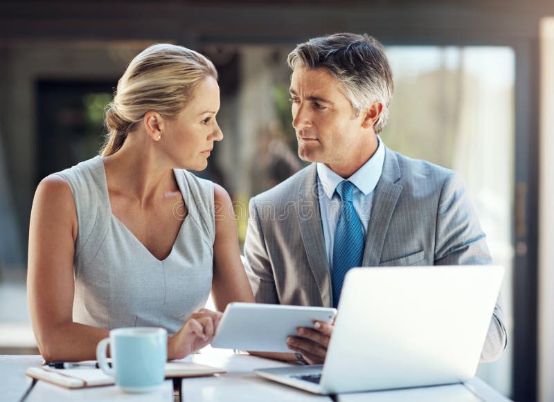 Hmm, Maybe that Could Work. a Mature Business Couple Looking ... Hmm, Maybe that Could Work. a Mature Business Couple Looking ...