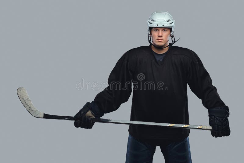 Hockey Player Wearing Black Protective Gear and White Helmet Holds a ... Hockey Player Wearing Black Protective Gear and White Helmet Holds a ...