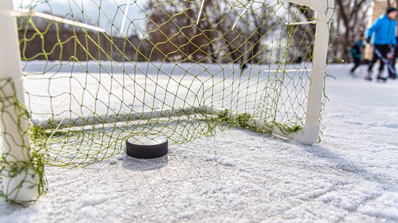 Hockey Puck in the Goal Net Close-up Stock Image - Image of hockey ...