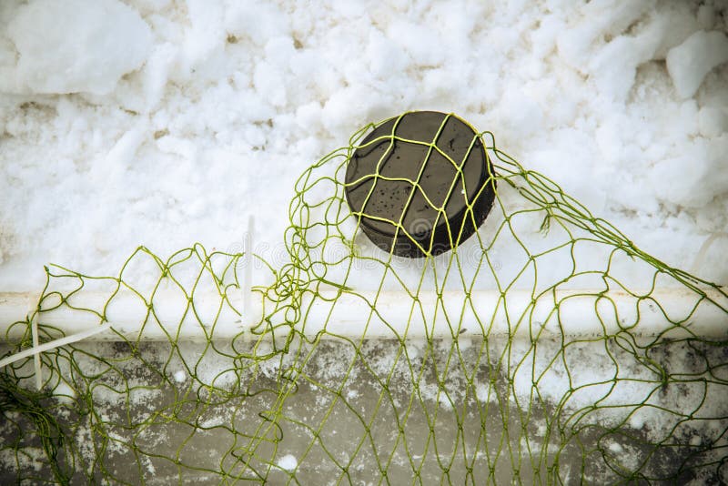 Hockey Puck in the Goal Net Close-up Stock Photo - Image of ...