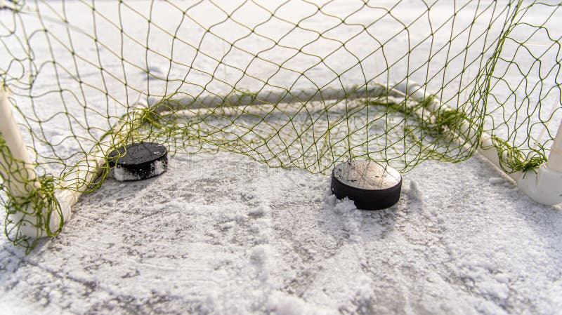 Hockey Puck in the Goal Net Close-up Stock Image - Image of black ...