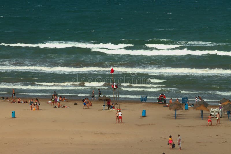 Hoisted Red Colors on Sea Beach. Valencia, Spain Editorial Photography ...
