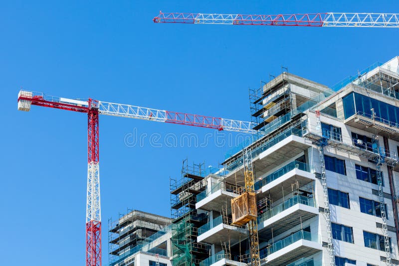 Hoisting crane and house stock image. Image of crane - 27890471
