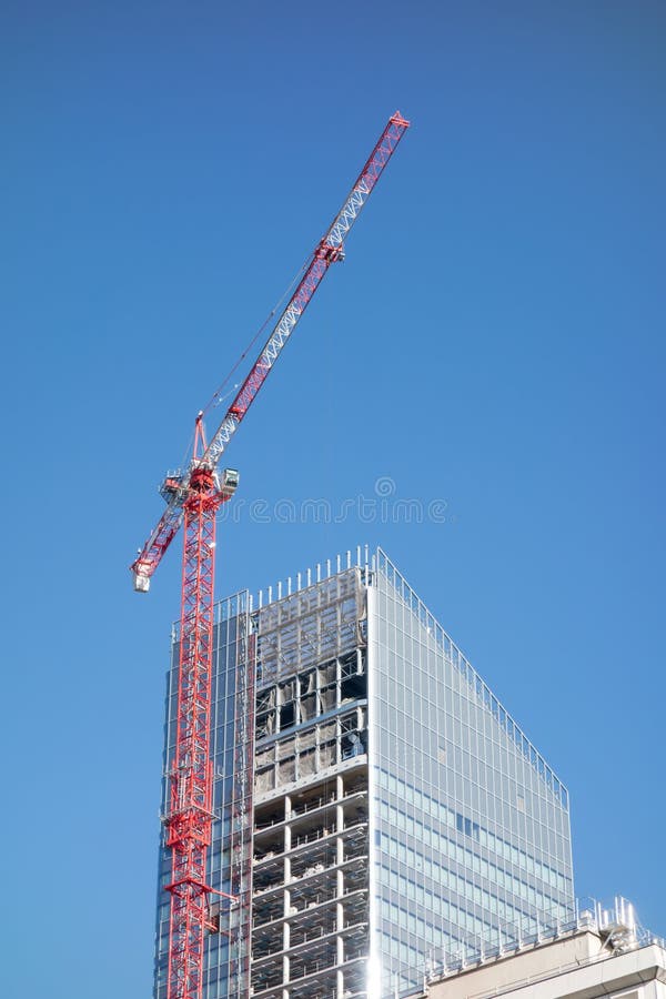 Hoisting Tower Crane on Top of Construction Skyscraper Building Over ...