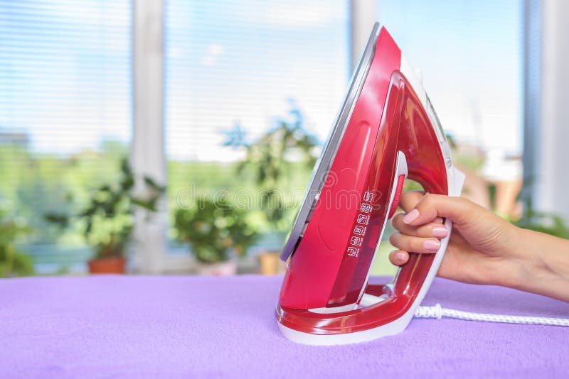 Hold in hand irons. stock photo. Image of housewife, domestic - 82787460