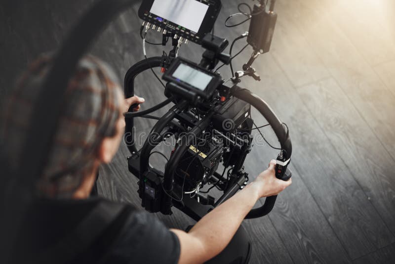 Hold it Steady. Behind the Scenes Shot of a Camera Operator Shooting a ...