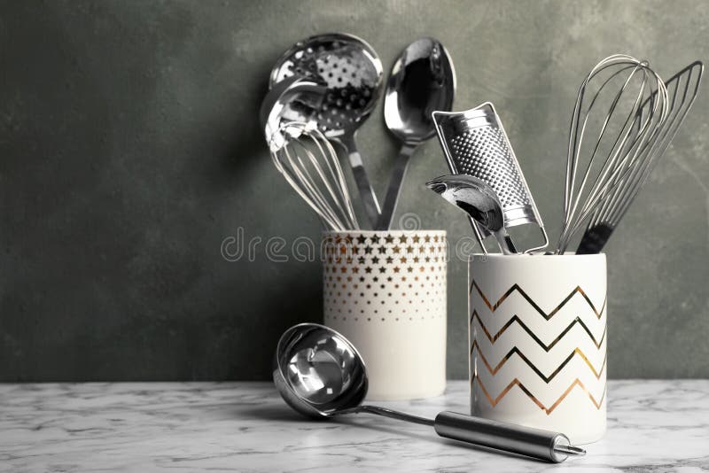 Holder with Clean Kitchen Utensils on Table. Stock Photo - Image of ...