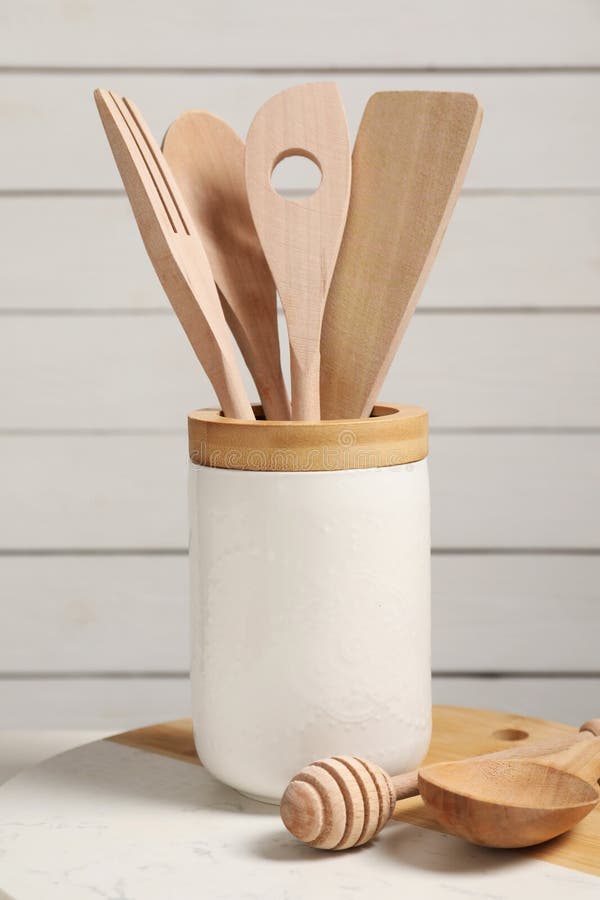 Holder with Set of Different Kitchen Utensils on White Table Stock ...