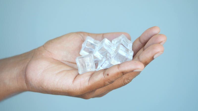 Holding Clear Ice Cubes in a Hand Against a Light Background Stock ...