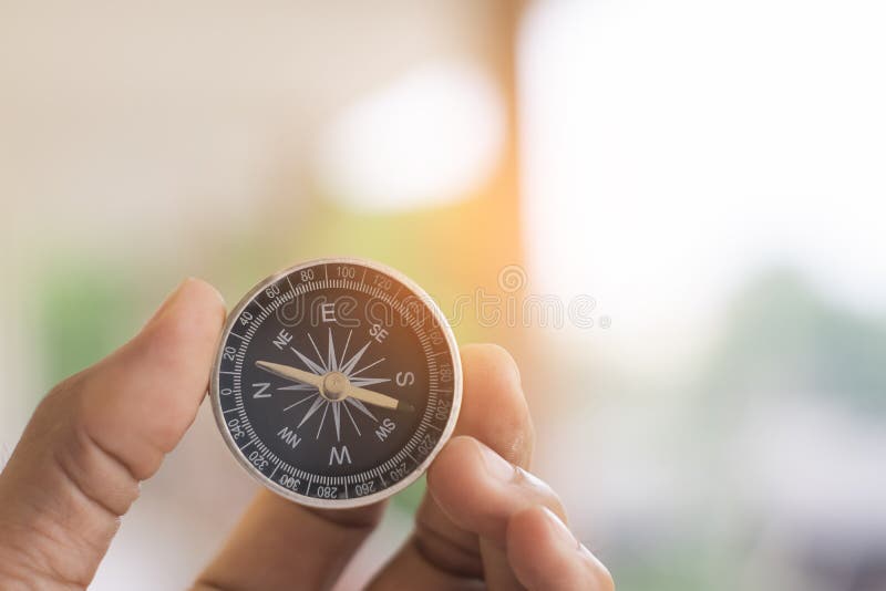 Holding Compass on Blurred Background. Using Wallpaper or Background ...